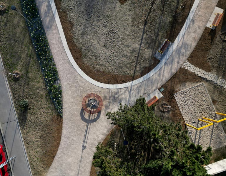 Circle-shaped Wood Bench with a Tree Growing in the Middle. Swings and ...