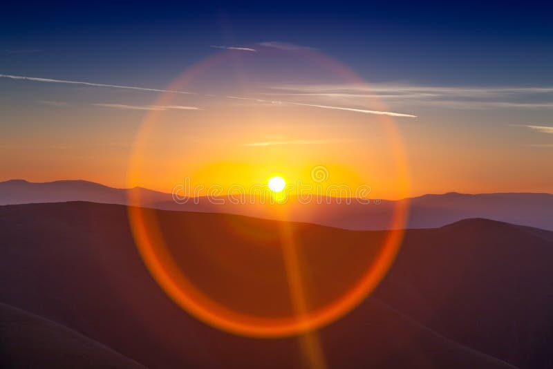Circle Sun Reflexion at Sunset Over Mountains Stock Photo - Image of ...