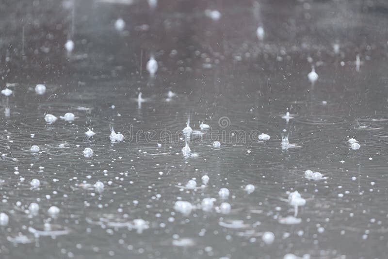 Circles and Raindrops in a Puddle Stock Image - Image of rain, melted ...