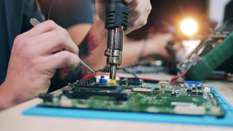 Engineer is Soldering a Microcircuit Under a Microscope Stock Footage ...