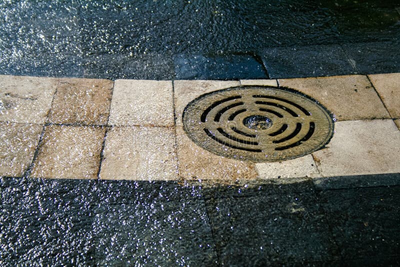 Circular Drain Cover Embedded in Light-Tiled Surface with Shimmering ...