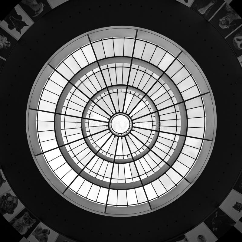 Circular Glass Dome Situated In The Center Of A Room Providing An Illuminated View Of The