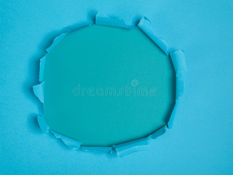 A Circular Hole Torn in Light Blue Paper, Revealing a Teal Background ...