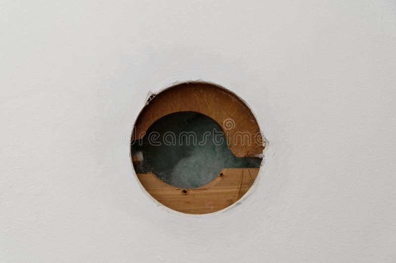 A Circular Hole from Where a Light Switch Has Been Moved, in a White ...