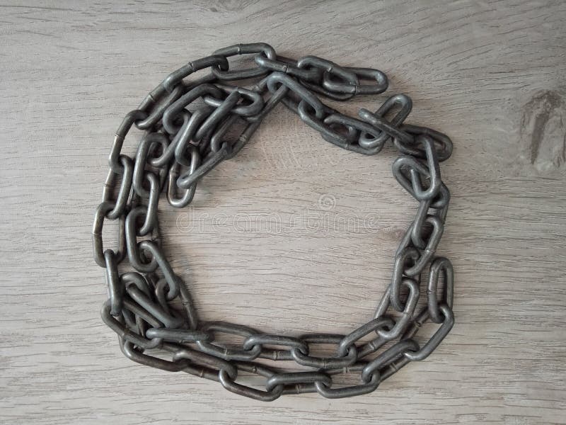 Circular Iron Chain on a Wooden Table Stock Image - Image of silver ...