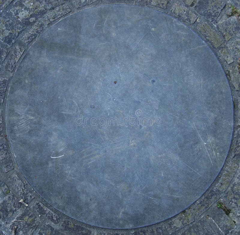 Circular Metal Plate Embedded in Cobble Stone Stock Photo - Image of ...