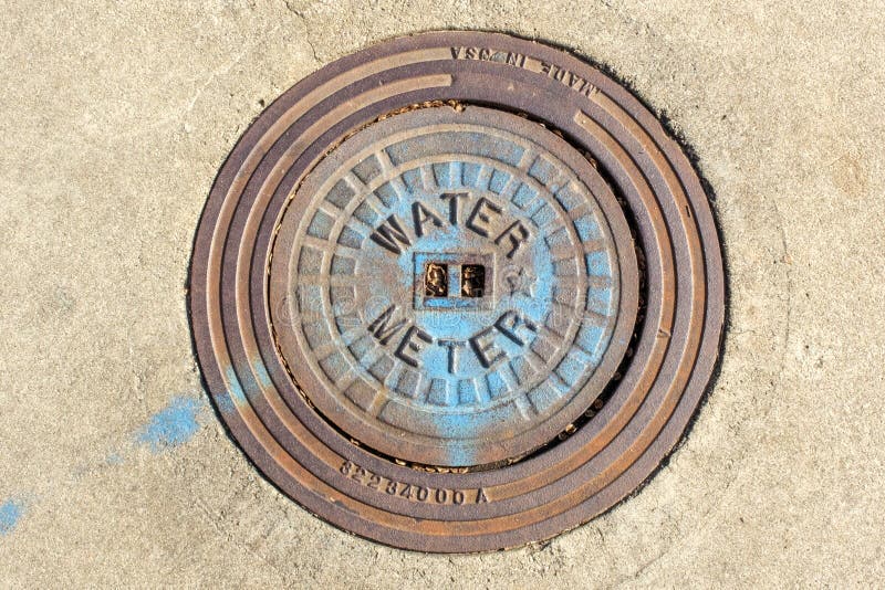 Circular Metal Water Meter Sign in a Sidewalk Stock Image - Image of ...