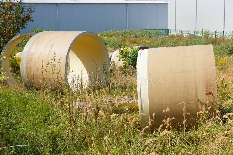 Circular Objects on a Field of Grass Surrounded by Trees Behind the ...