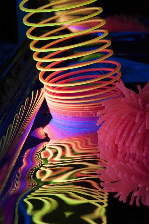 Circular Objects are Lit with Fluorescent Colors Against a Deep Blue ...