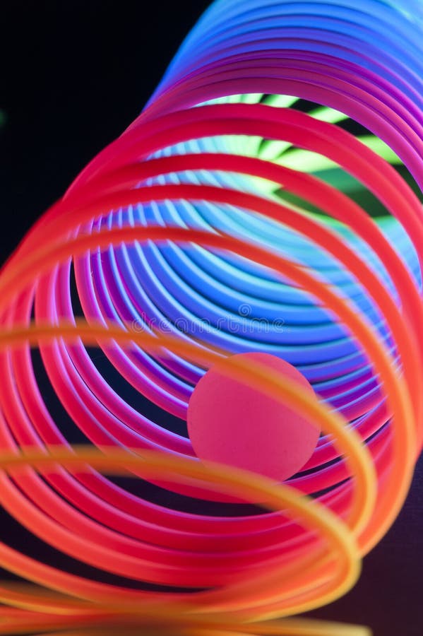 Circular Objects are Lit with Fluorescent Colors Against a Deep Blue ...