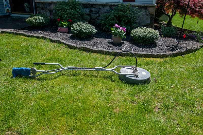 Circular Pressure Washer with Hose Attached on a Green Grass Lawn Stock ...