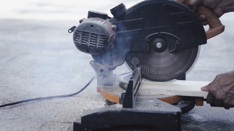 A Circular Saw in Action, Cutting through a Piece of Wood. the Image ...