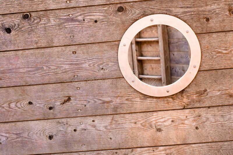 Circular Window is Set into a Wooden Wall with Aged Iron Nails ...