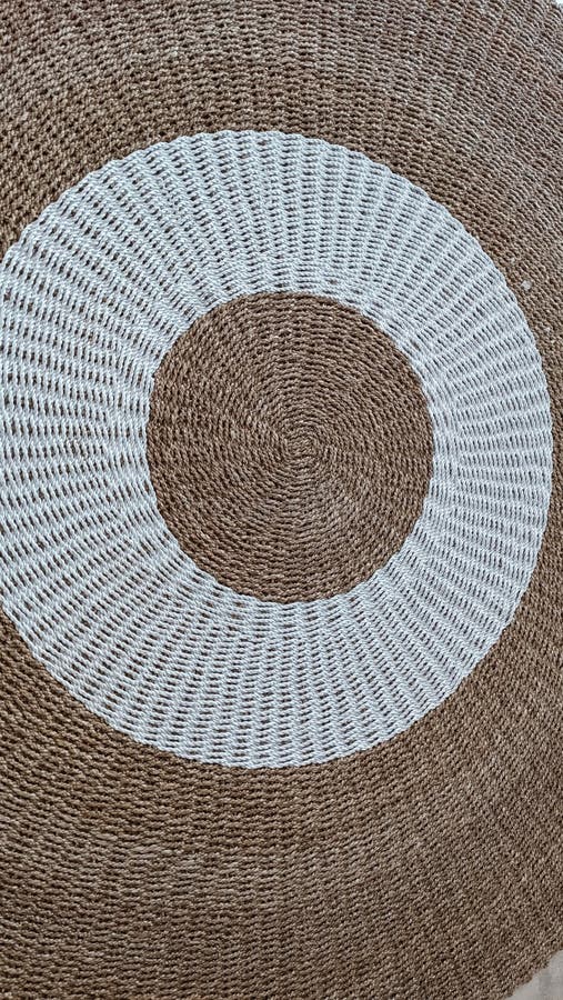 Circular Woven Mat with White Pattern on Wooden Floor Stock Image ...