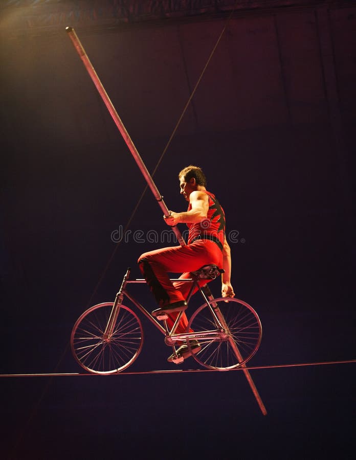 High Wire Circus Act with Bike Stock Photo - Image of background, fear ...