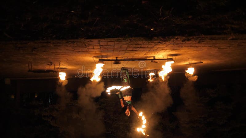 A Circus Artist Performs a Fire Dance in the Darkness, Slow Motion ...
