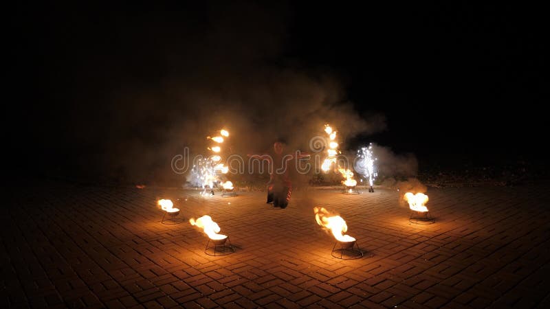 A Circus Artist Performs a Fire Dance in the Darkness, Slow Motion ...