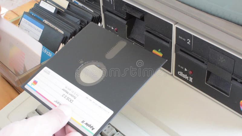 Aged Apple Computer and Hand Insert Floppy Inside Then Typing on ...