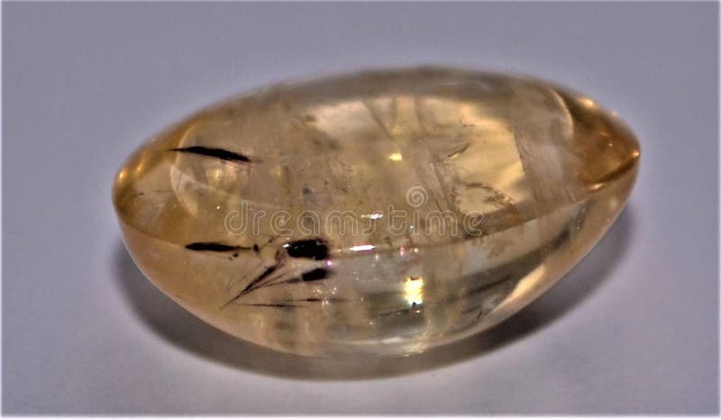 Citrine with Rutile Inclusions in a Cabochon Shape Stock Photo - Image ...