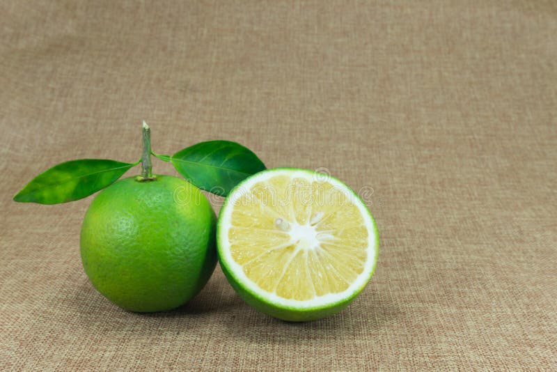 Citrus Fruit, Composition with Leaves on Brown Fabric Background Stock ...