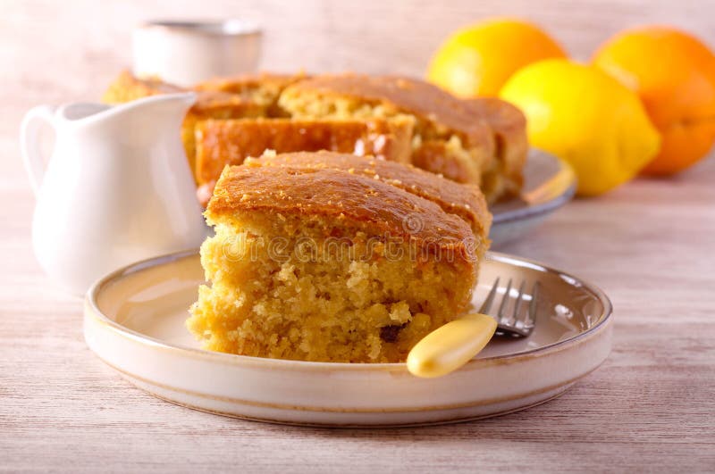 Citrus poke cake, sliced stock image. Image of syrup - 259099943