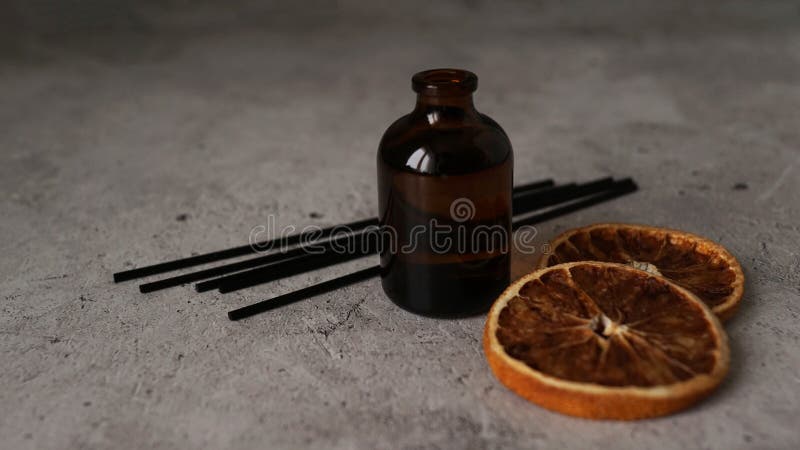 Citrus Reed Diffuser on Dark Background. Bottle, Sticks and Dry Oranges ...