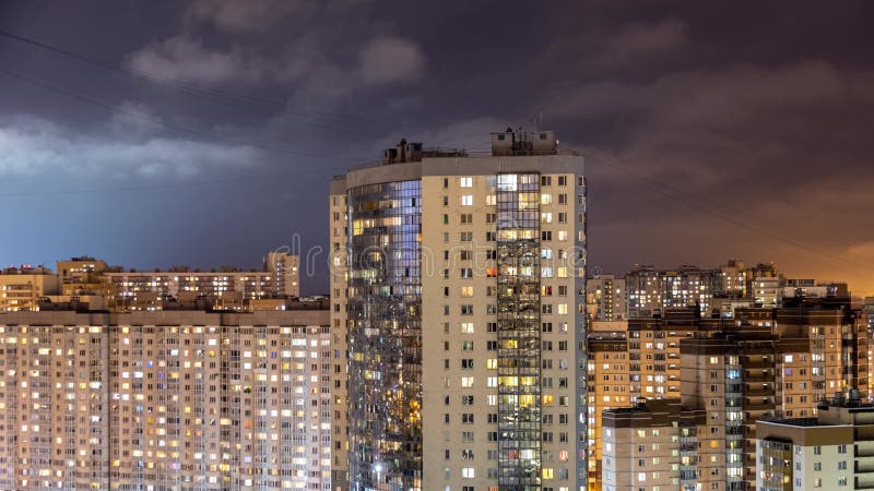 At Night, Windows in an Office Building are Illuminated through the ...