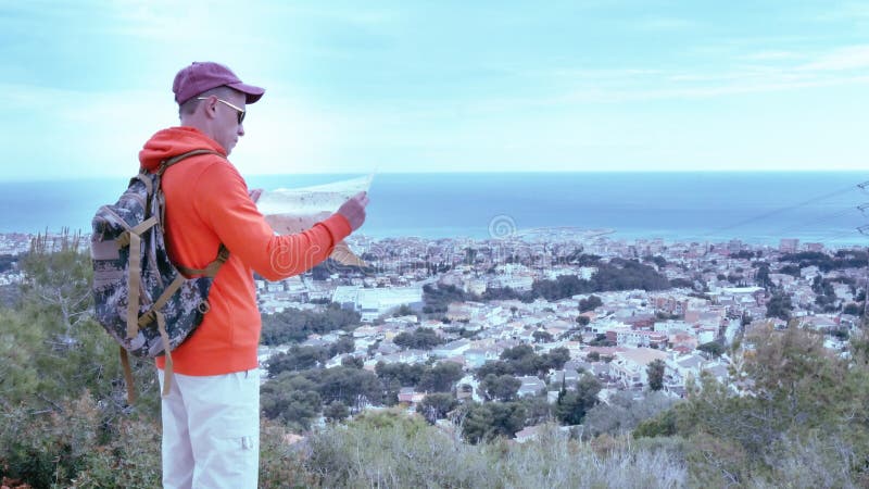 City Exploration: Adventurous Man Standing Atop, Studying City Map ...