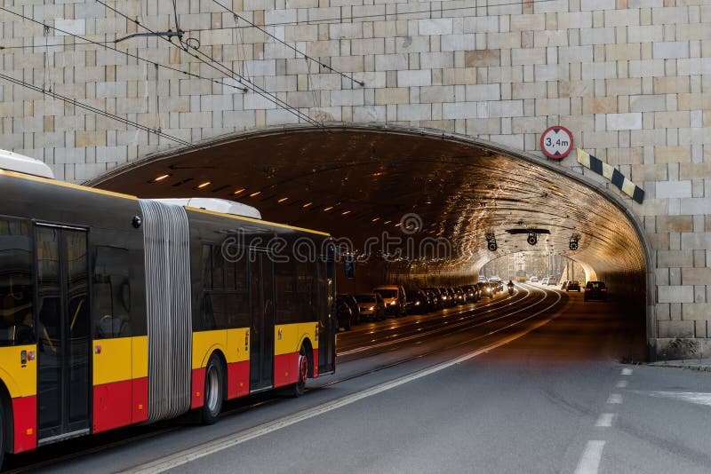 The City Long Bus Drives into the Tunnel Under the Bridge. Stock Image ...