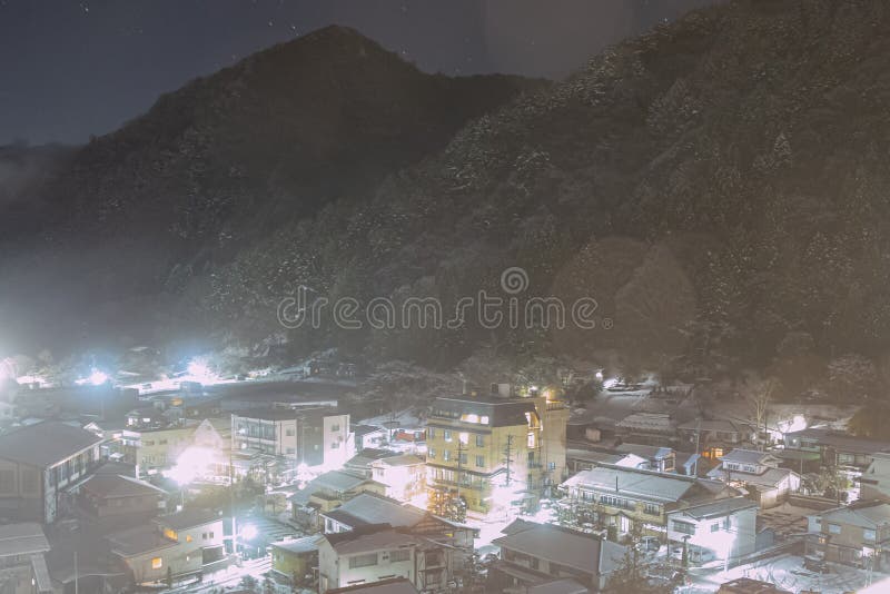 City and Mountains Covered by Snow at Night Stock Photo - Image of ...