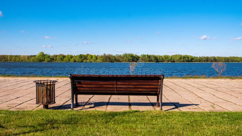 The City Park. an Empty Bench Overlooking the Water Surface Stock Photo ...