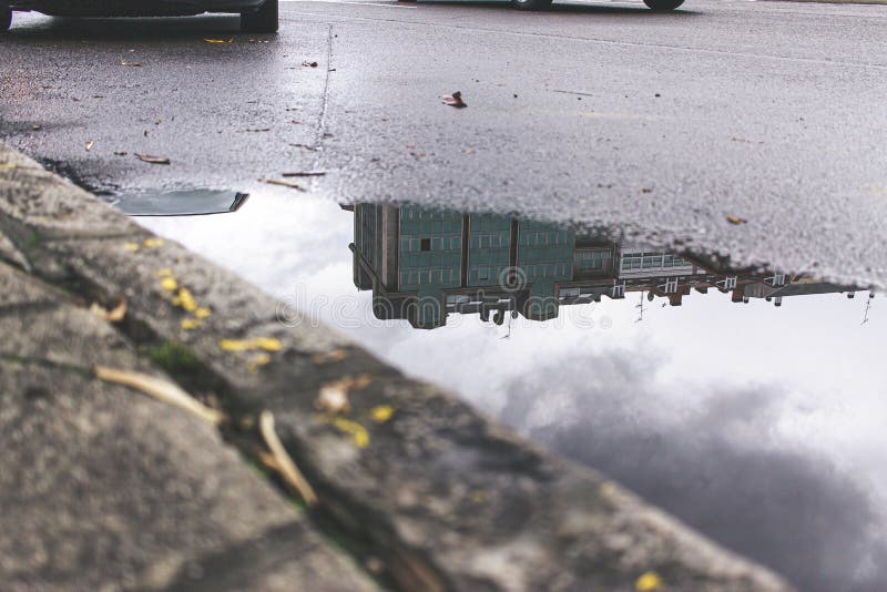 City Reflected in a Puddle of Rain Stock Image - Image of abstract ...
