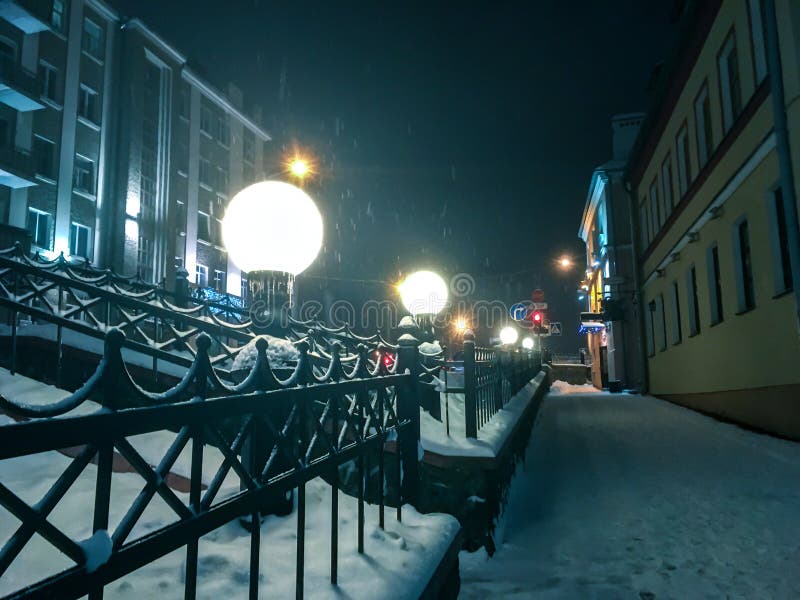 City Street Covered with Snow at Night with Bright Glowing Lanterns ...