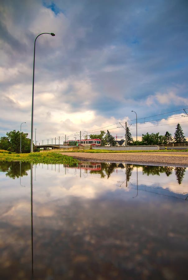 City Transit and Cloud Reflections in a Puddle Editorial Photo - Image ...