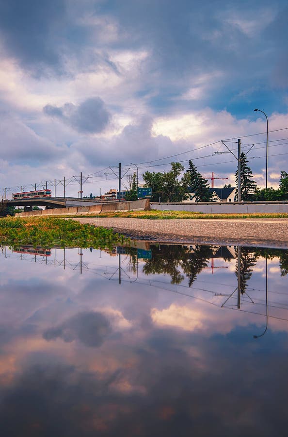 City Transit and Cloud Reflections in a Puddle Editorial Stock Image ...