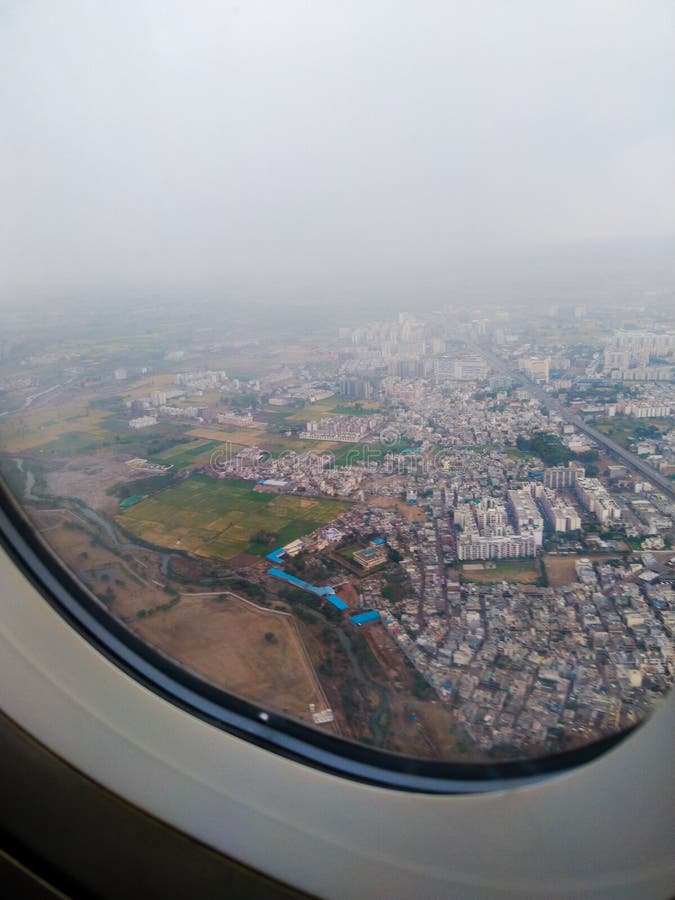 A City View from a Plane Window during Flight, Clouds in Blue Sky Stock ...