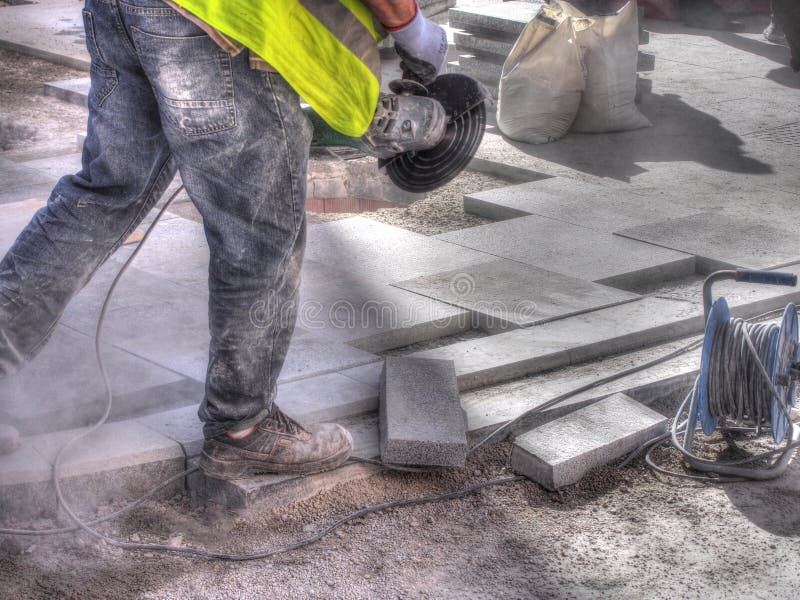City Workers - Disc Grinder and Paving Slab, Spain Stock Image - Image ...