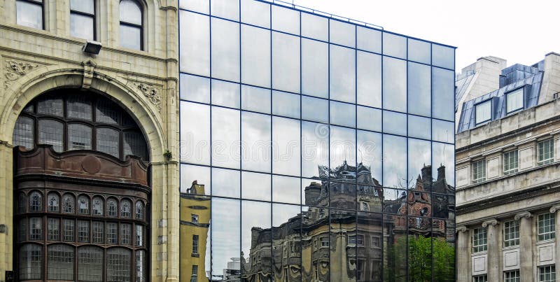 Buildings Reflected in a Sleek Glass Building Facade Stock Photo ...