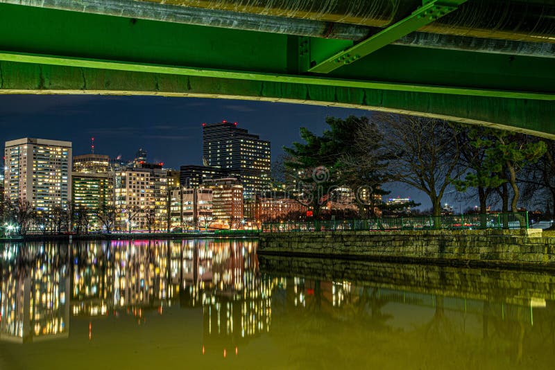 Cityscape and the Reflection of the Buildings with Lights on a River at ...