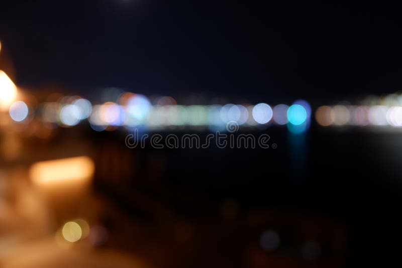 Cityscape with Sea View in Unfocused Night Lighting, Blurred Lights in ... Cityscape with Sea View in Unfocused Night Lighting, Blurred Lights in ...
