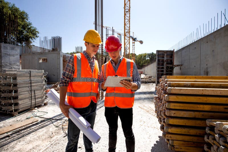 Civil Architect and Construction Manager Dressed in Orange Work Vests ...