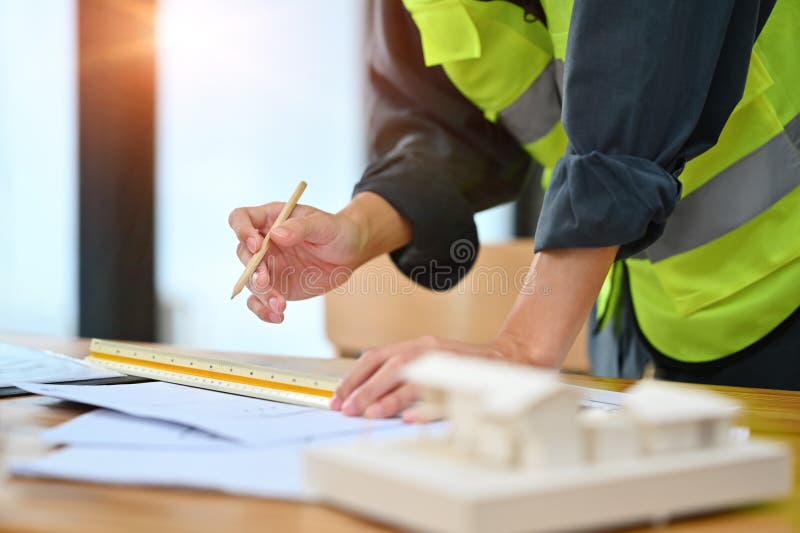 Two Men Working on Blueprints at a Table Stock Image - Image of ...