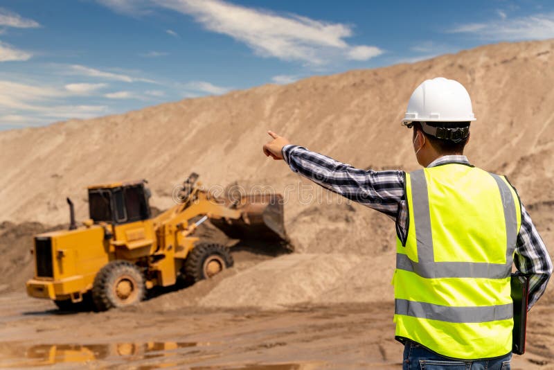 Civil Engineer Control Work of Yellow Excavator Working at Sandpit ...