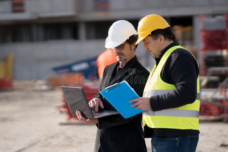 Civil Engineer Giving Instructions To Construction Worker Stock Photo ...