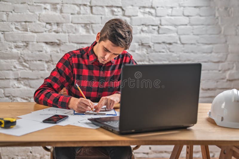 Civil Engineer at His Desk Working with Documents Stock Photo - Image ...