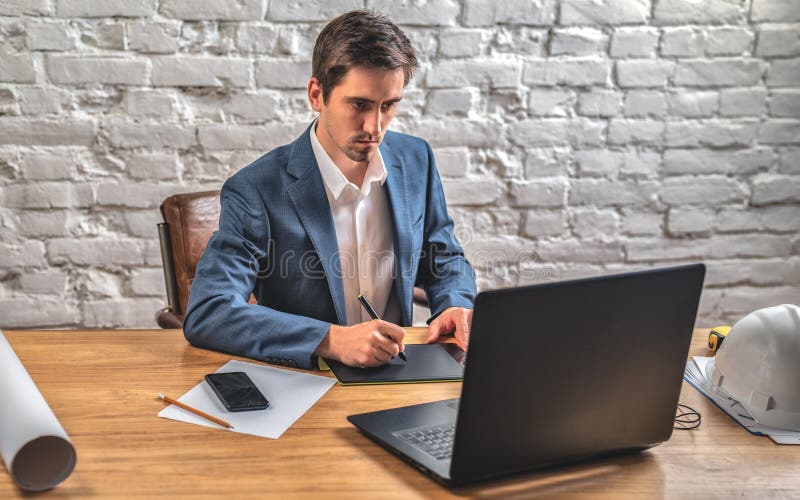 Civil Engineer at His Desk Working with Documents Stock Photo - Image ...