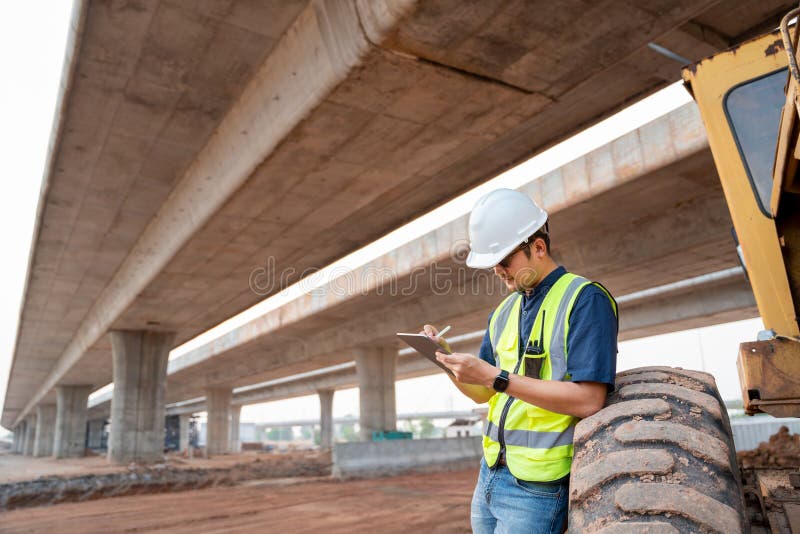 A Civil Engineer Standing Pointing at a Road or Expressway Construction ...