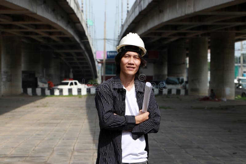 Civil Engineer Man with Helmet, Standing and Hugging Chest with Project ...