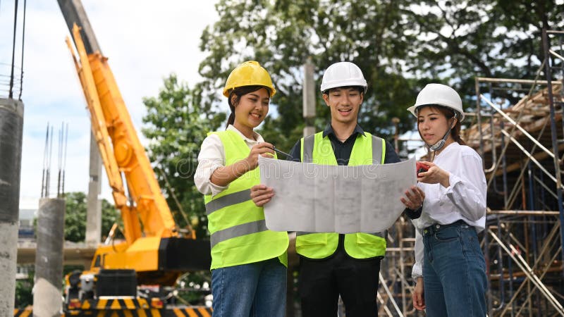 Civil Engineer Managers in Safety Helmet are Discussing Plan Details ...