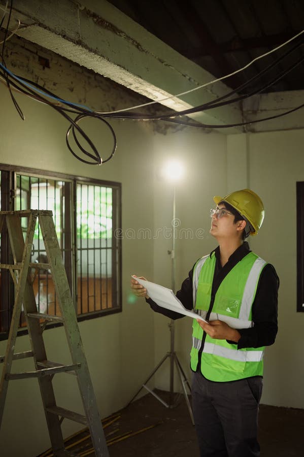 Civil Engineer Reviews Ceiling Installation Details during Home ...